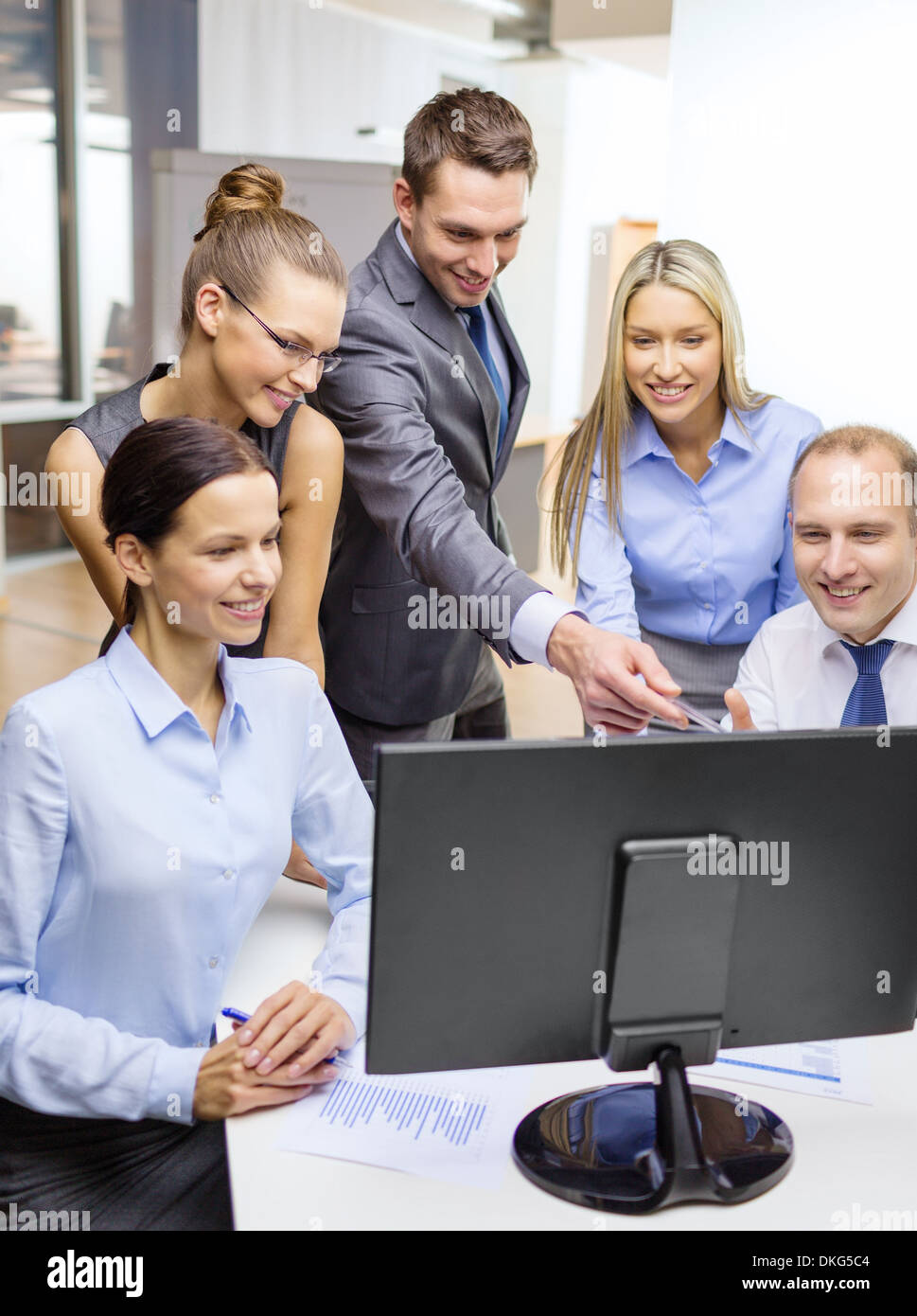business team with monitor having discussion Stock Photo - Alamy