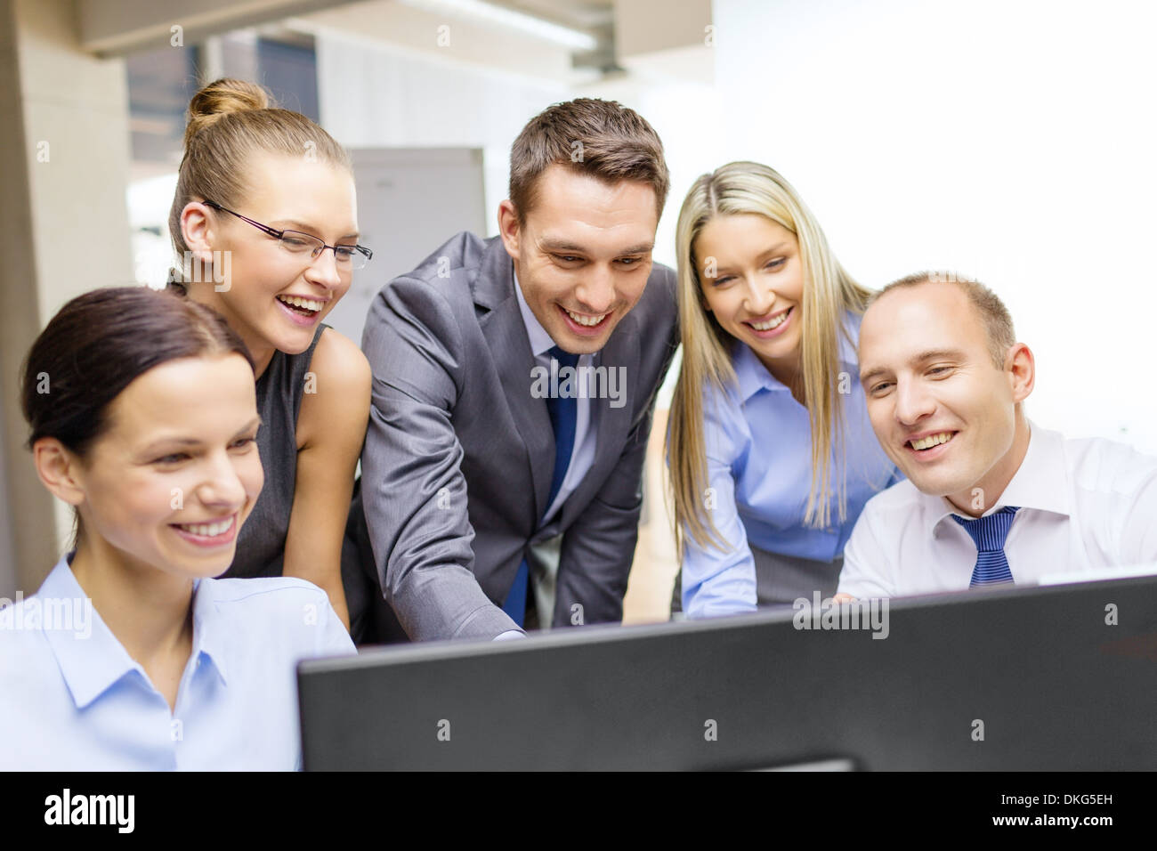 business team with monitor having discussion Stock Photo - Alamy