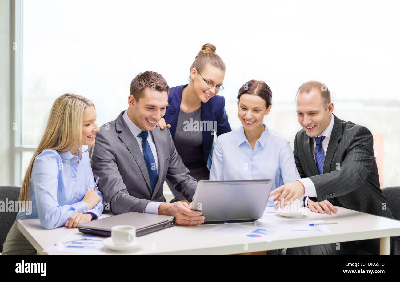 business team with laptop having discussion Stock Photo - Alamy