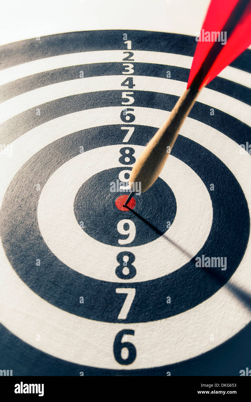 A wooden dart hits the center bullseye of a dartboard Stock Photo - Alamy