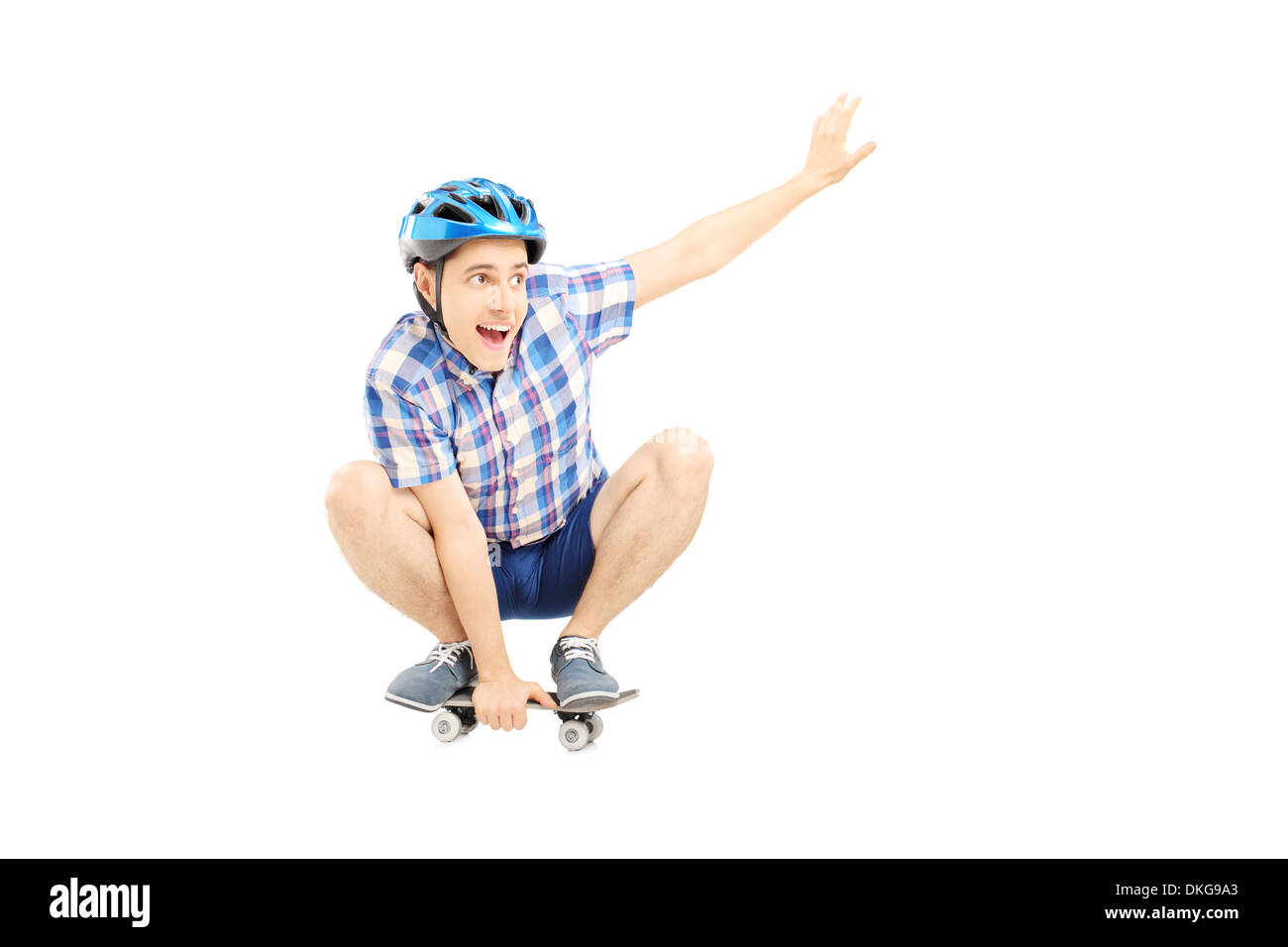 Happy guy with helmet skating on a skate board Stock Photo - Alamy
