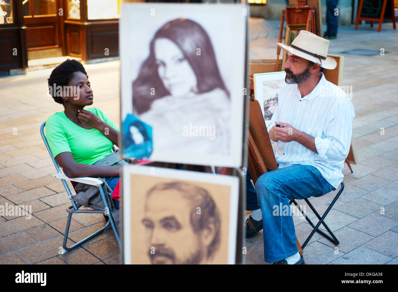 Unknown painters drawing the portraits of tourists at Old Town street ...