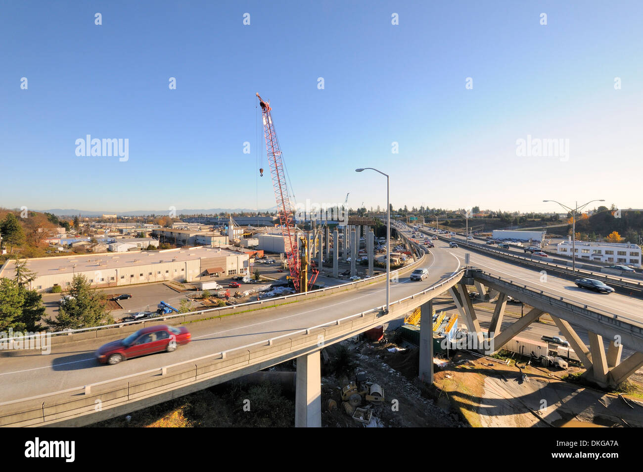 Freeway overpass with highway construction site underneath. There is ...