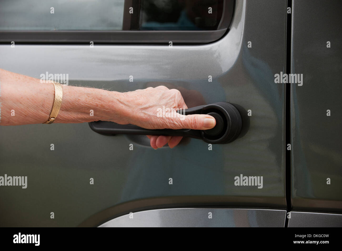 Woman's hand opening car using the door handle Stock Photo - Alamy