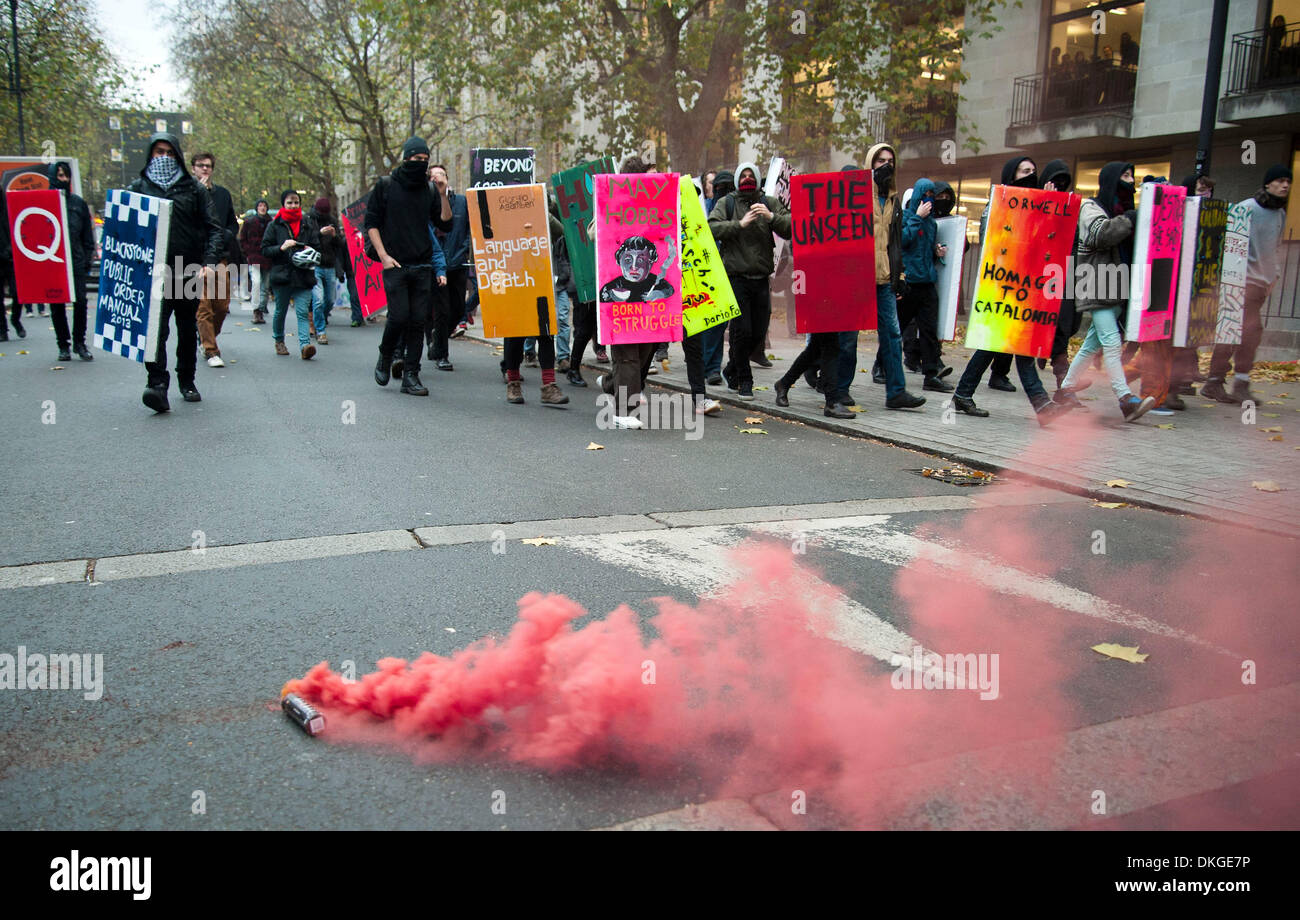 London, UK. 5th Dec, 2013. Protesters carrying home made banner riot ...