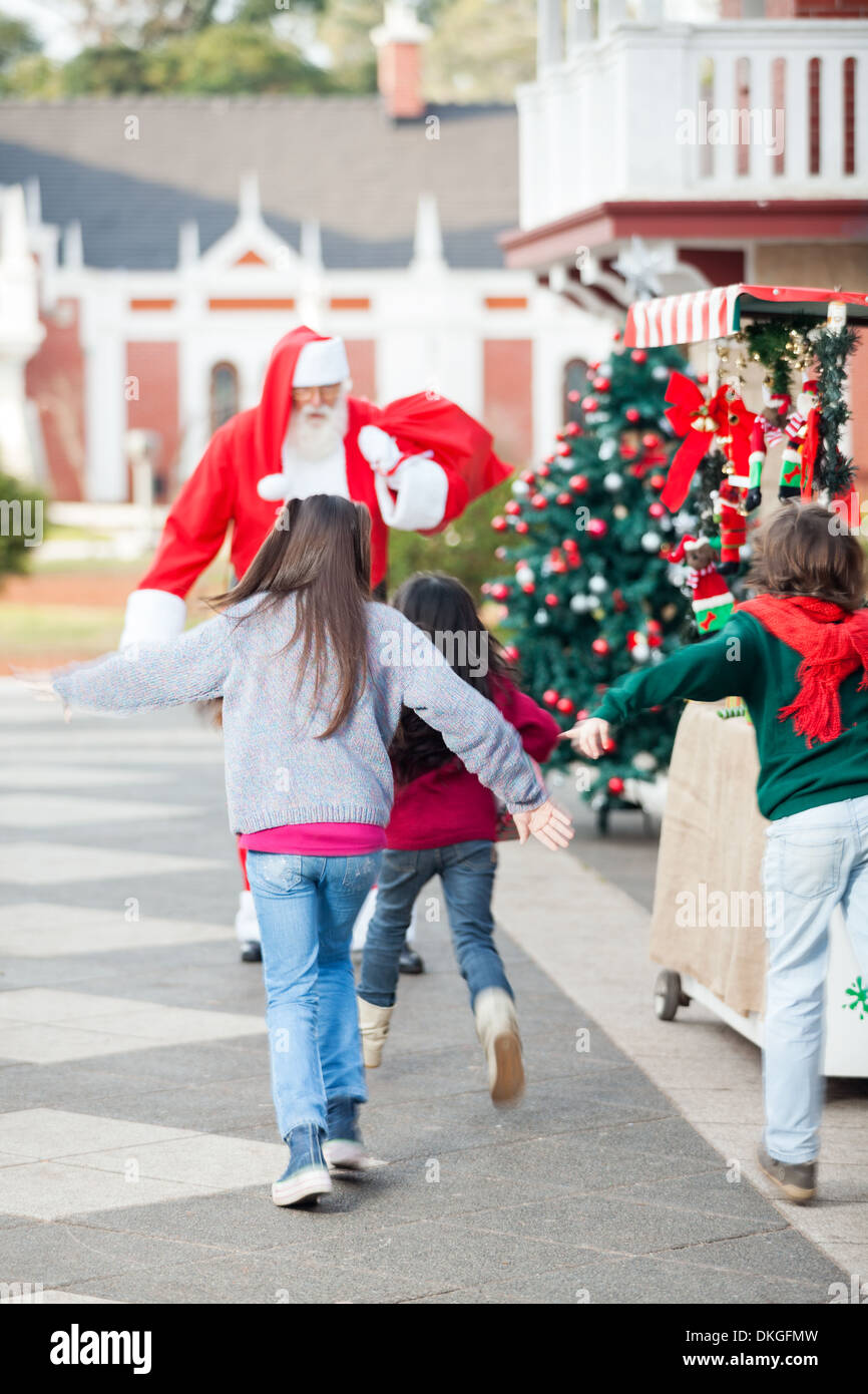 Children running christmas tree hi-res stock photography and images - Alamy
