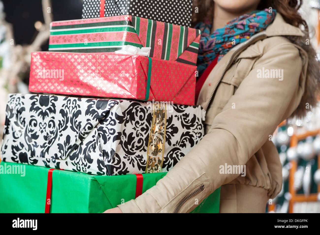 Woman Carrying Stacked Christmas Gifts Stock Photo - Alamy