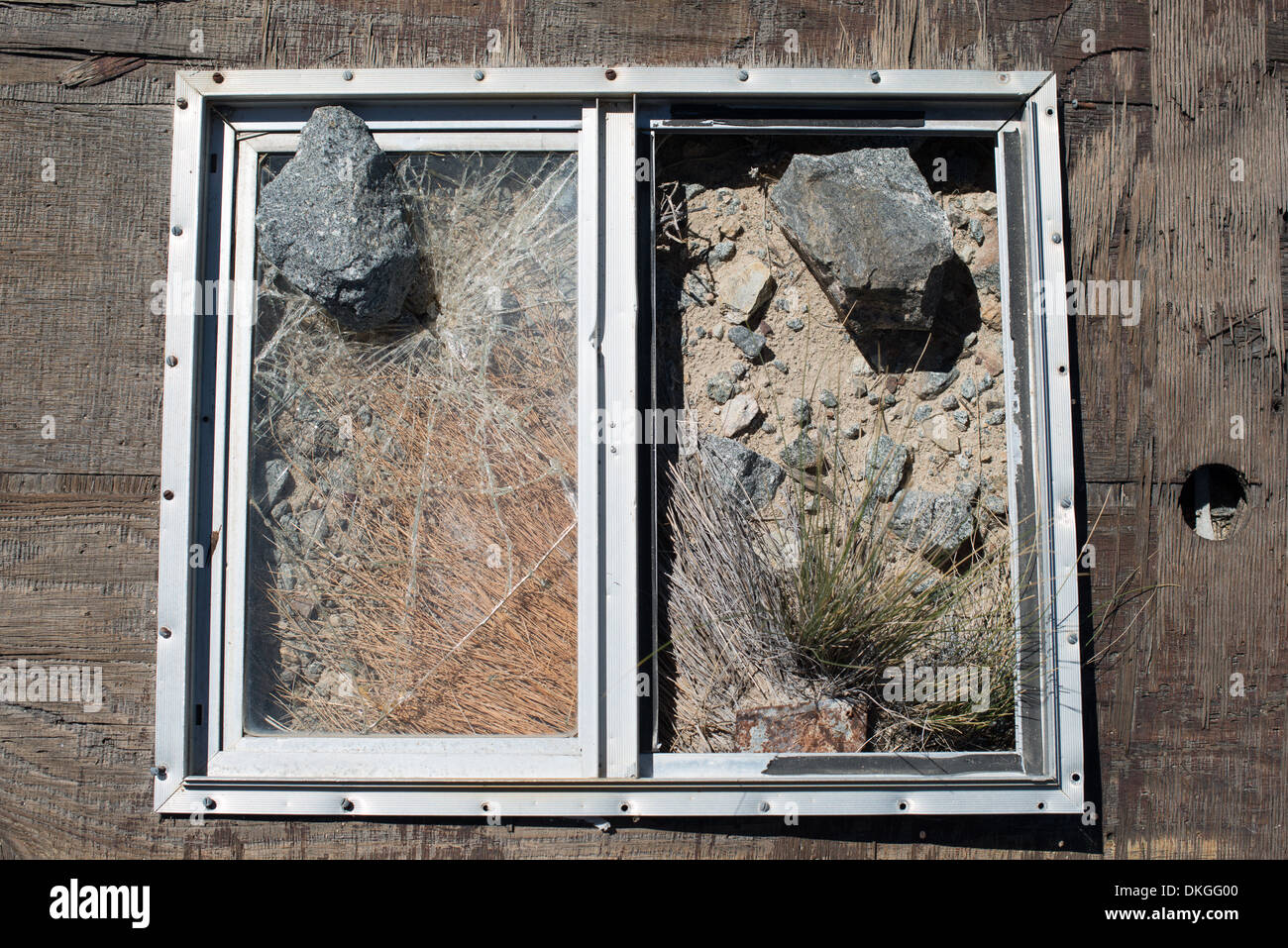 Broken window on the sand Stock Photo - Alamy