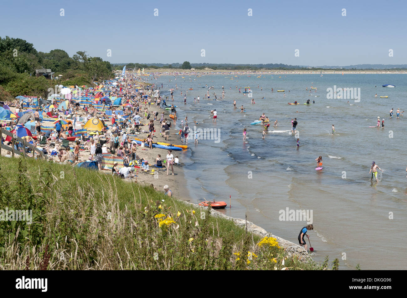 Studland bay beach packed with people on a hot summers day on the Isle ...