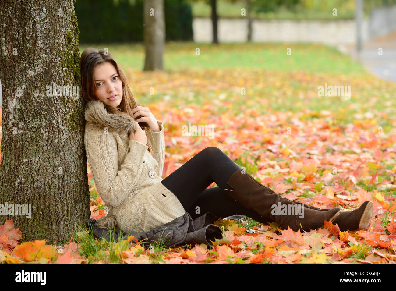 Woman sitting under tree in hi-res stock photography and images - Alamy