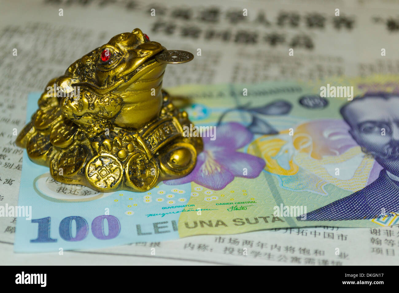 Money toad on Chinese newspaper and 100 Romanian lion banknote (RON ...