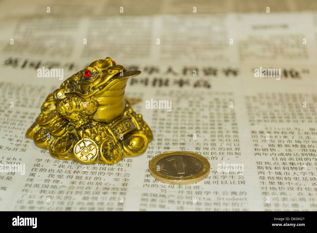 Money toad on Chinese newspaper near one Bulgarian leva coin (BGN Stock ...