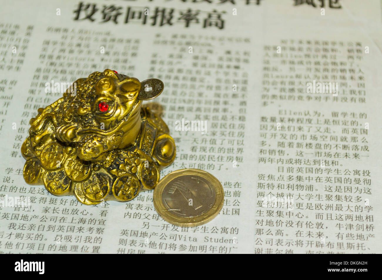 Money toad on Chinese newspaper near one Bulgarian leva coin (BGN Stock ...