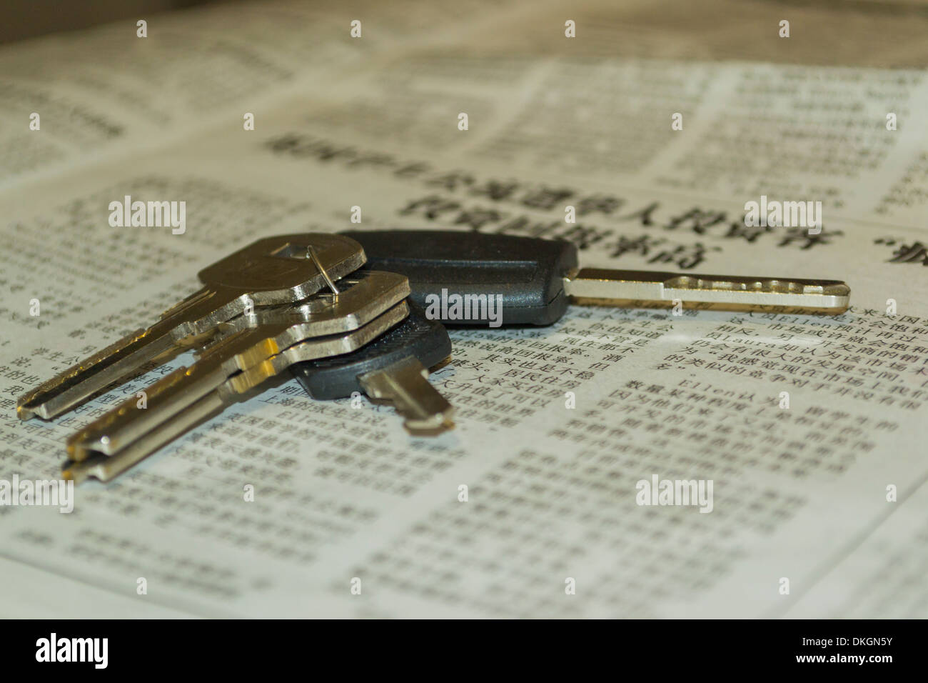 Door keys on a Chinese newspaper Stock Photo - Alamy