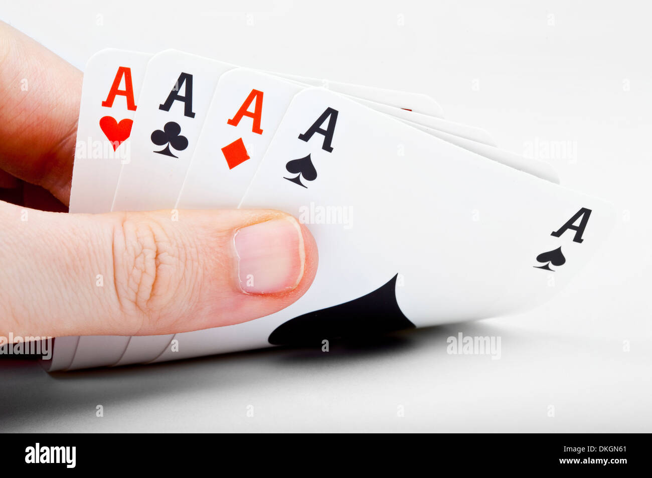Hand of Four Aces over a white background Stock Photo - Alamy
