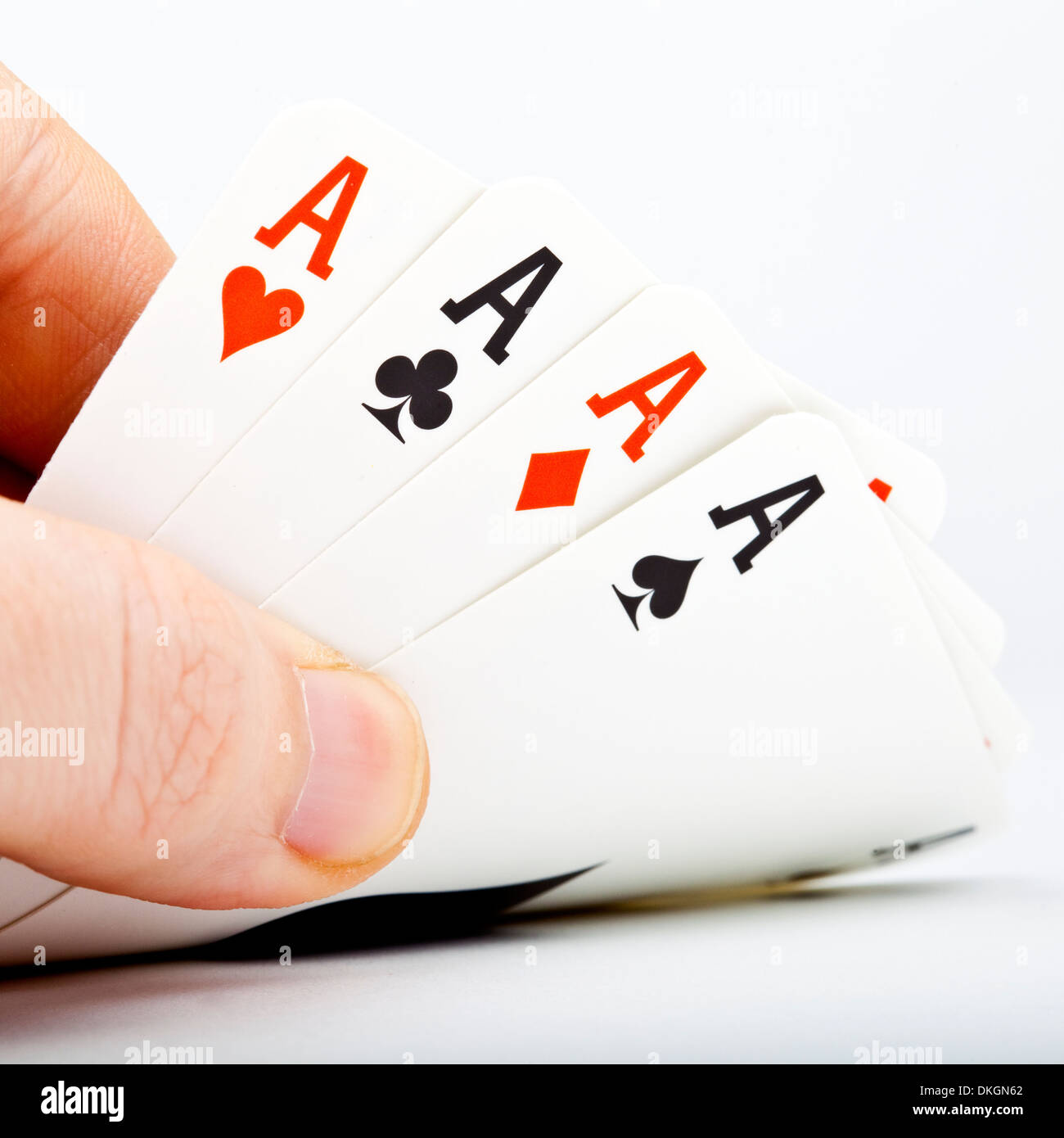 Hand and Four Aces over a white background Stock Photo - Alamy