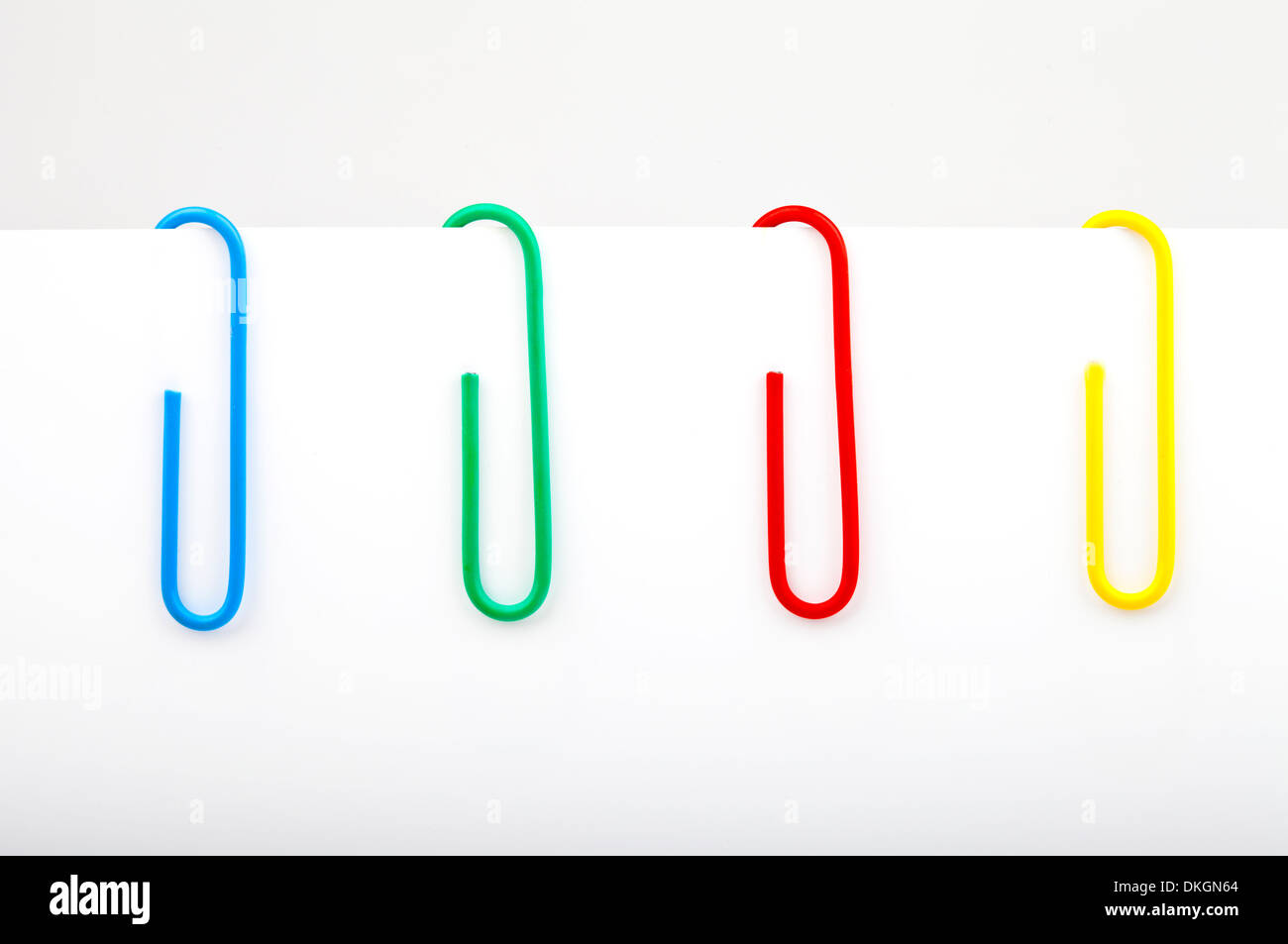 Paper Clips attached to a sheet of paper Stock Photo - Alamy