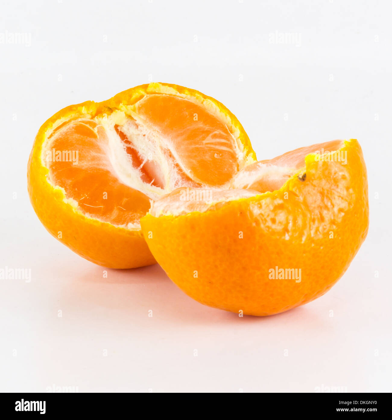 Two segments of orange isolated on white background Stock Photo - Alamy