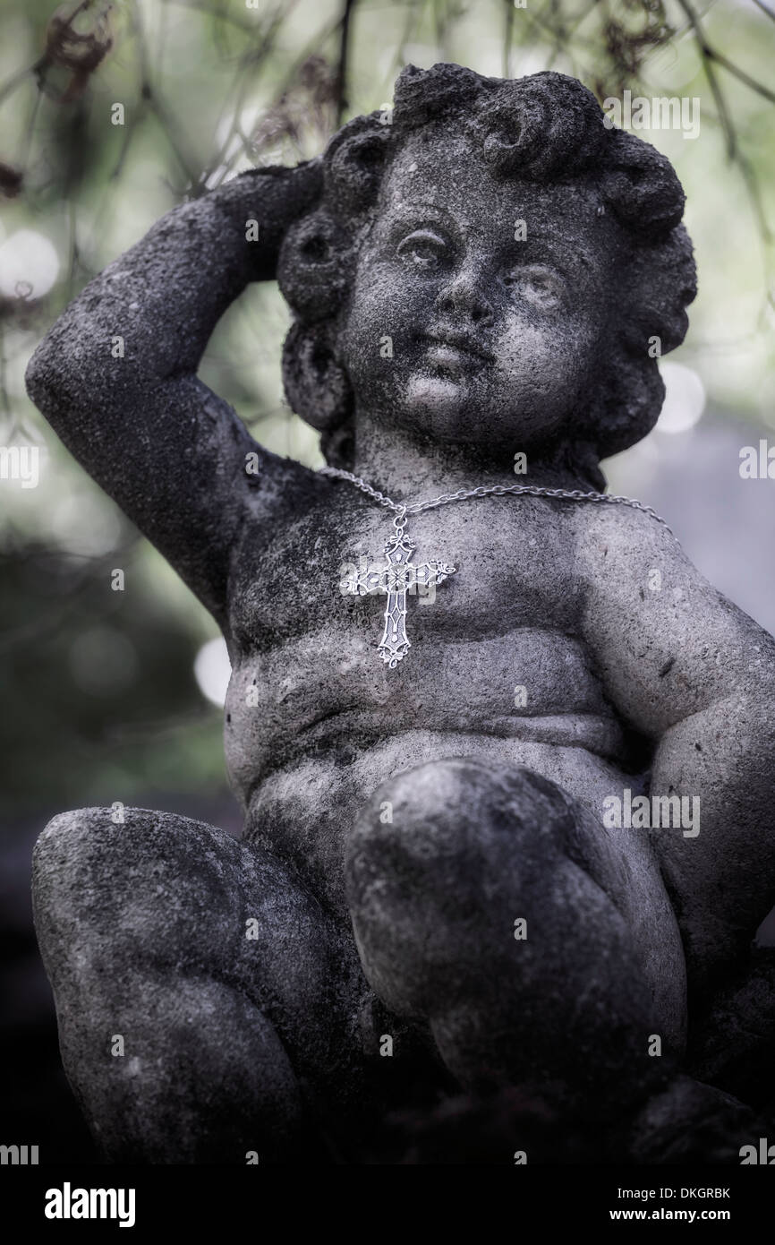 a stone angel with a crucifix Stock Photo - Alamy