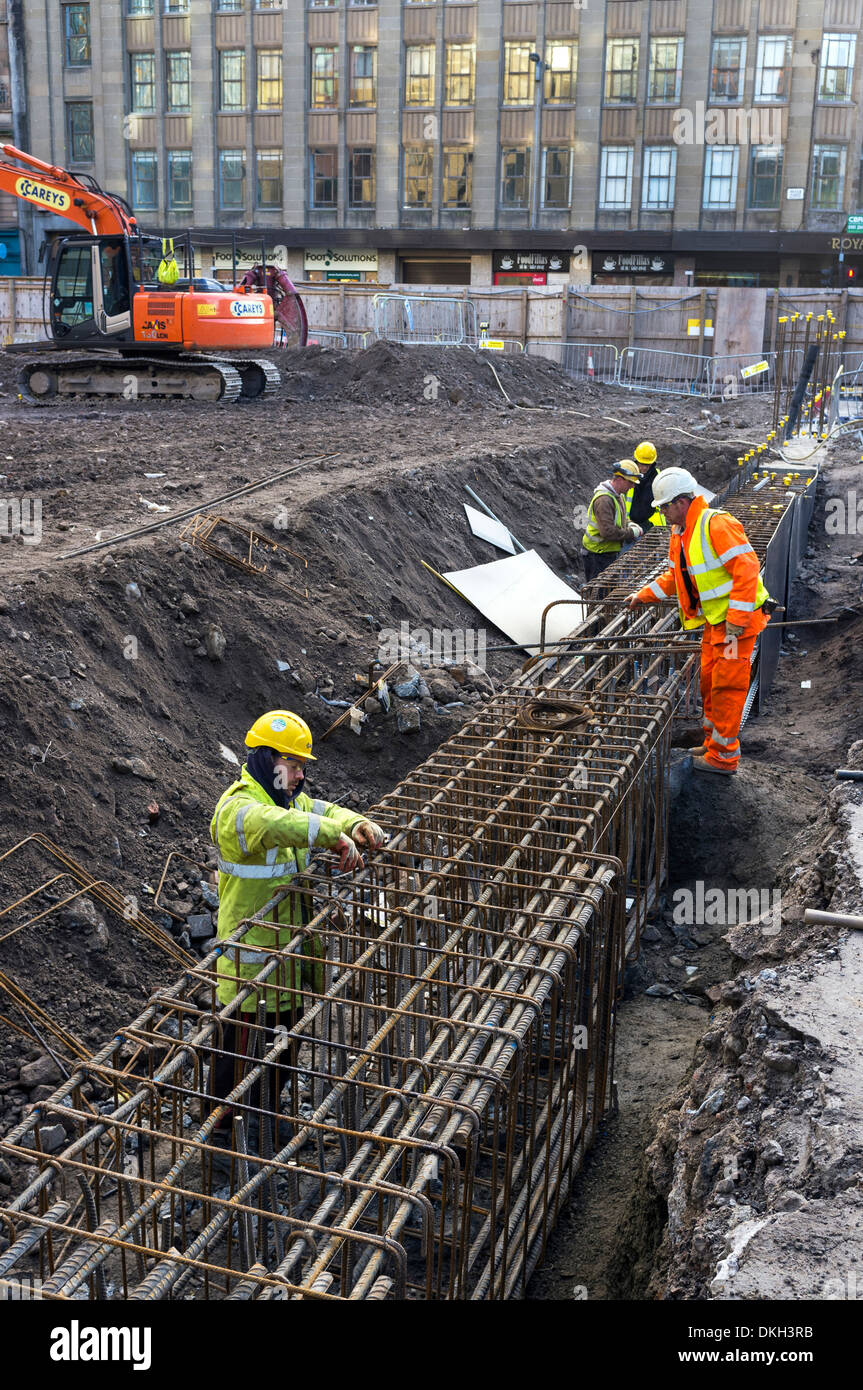 Workmen preparing the structure for concrete building foundations ...