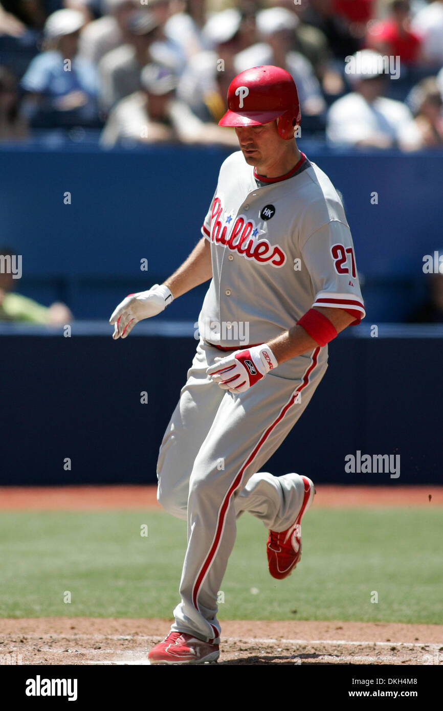 Philadelphia Phillies catcher Chris Coste (27) hitting home plate in a ...