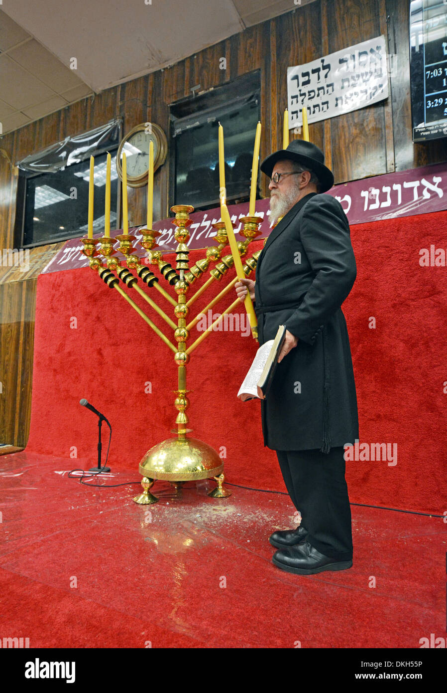 An orthodox Jewish rabbi prepares to light Hanukkah candles at ...