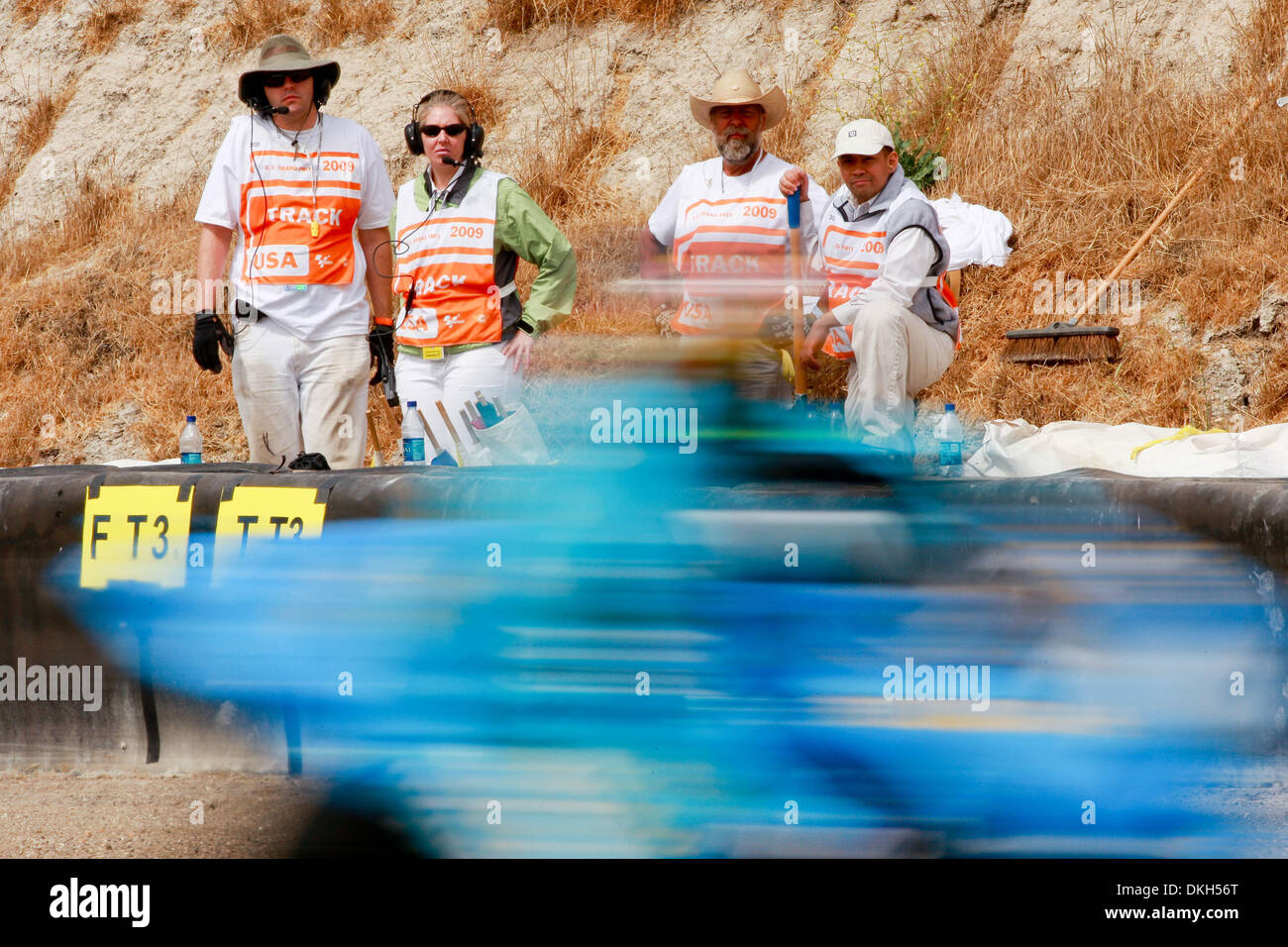 Track workers look on during MotoGP practice at the Mazda Raceway ...