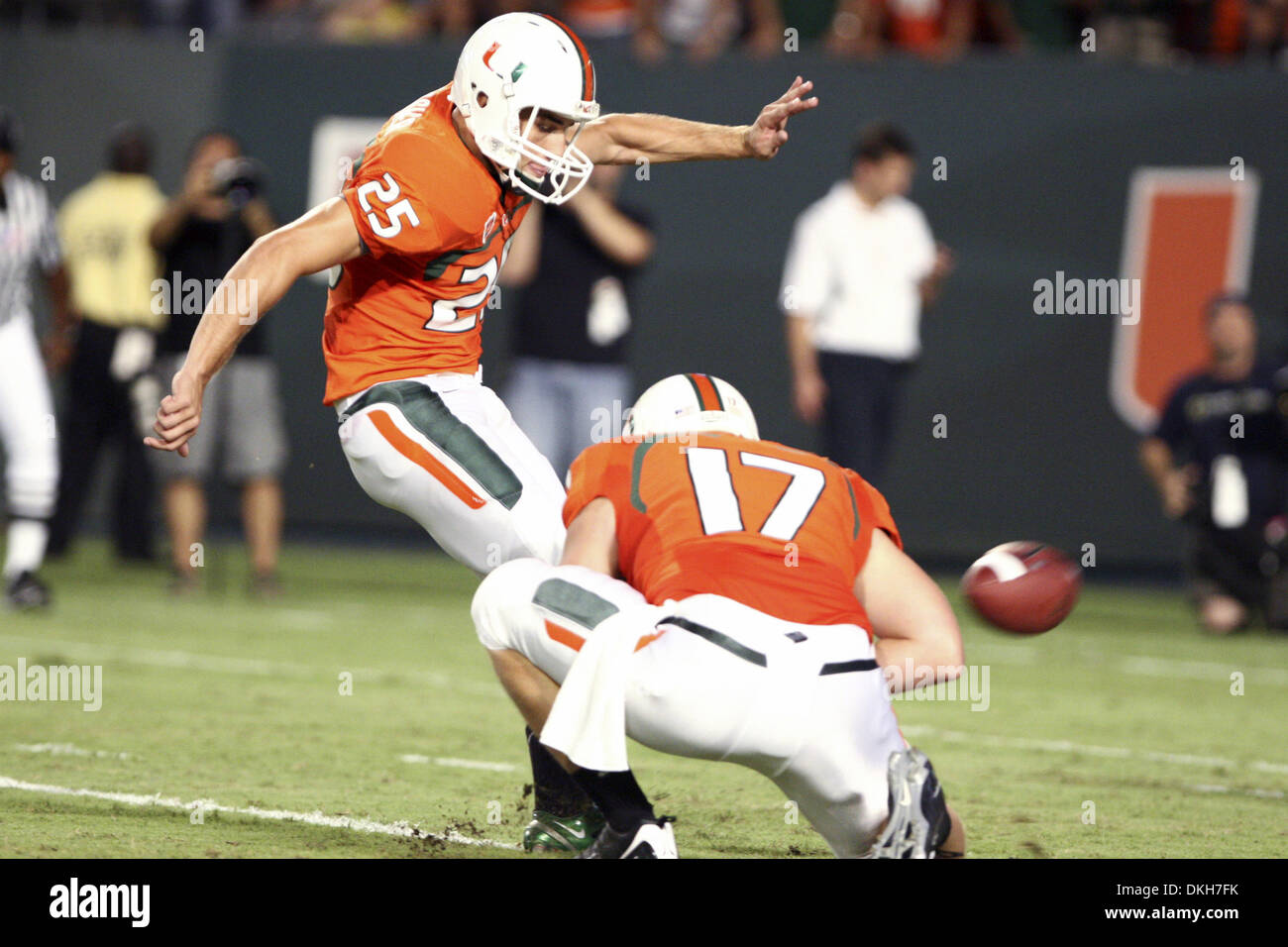 Miami Hurricanes kicker Matt Bosher (25) kicks off while quarterback ...