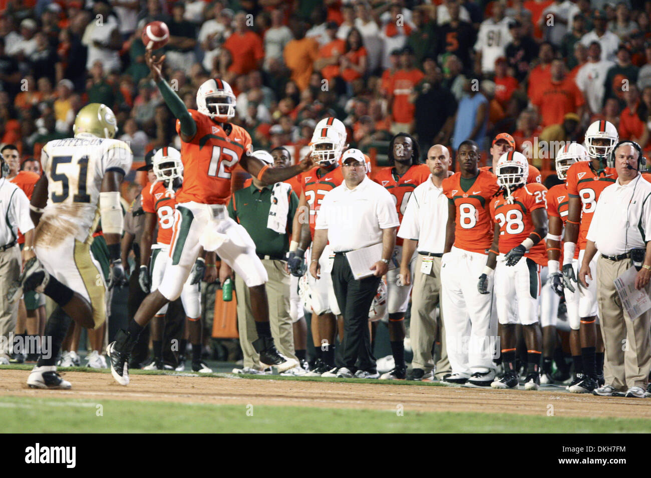 Miami Hurricanes quarterback Jacory Harris (12) looks to pass while hit ...