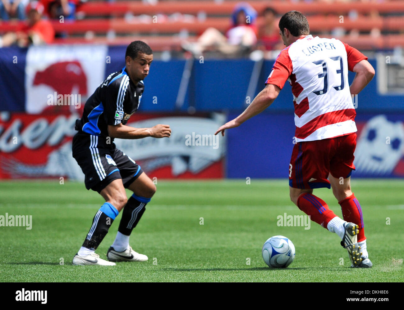 FC Dallas forward Kenny Cooper looks to drive past the Quakes defender ...