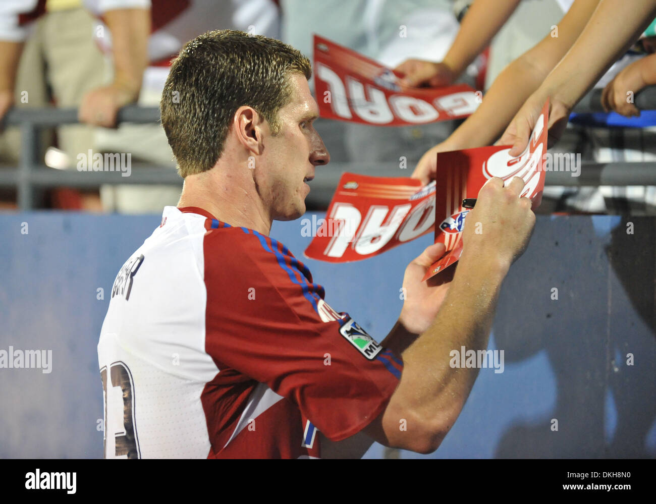 Forward Kenny Cooper stops for autographs after FC Dallas's victory ...