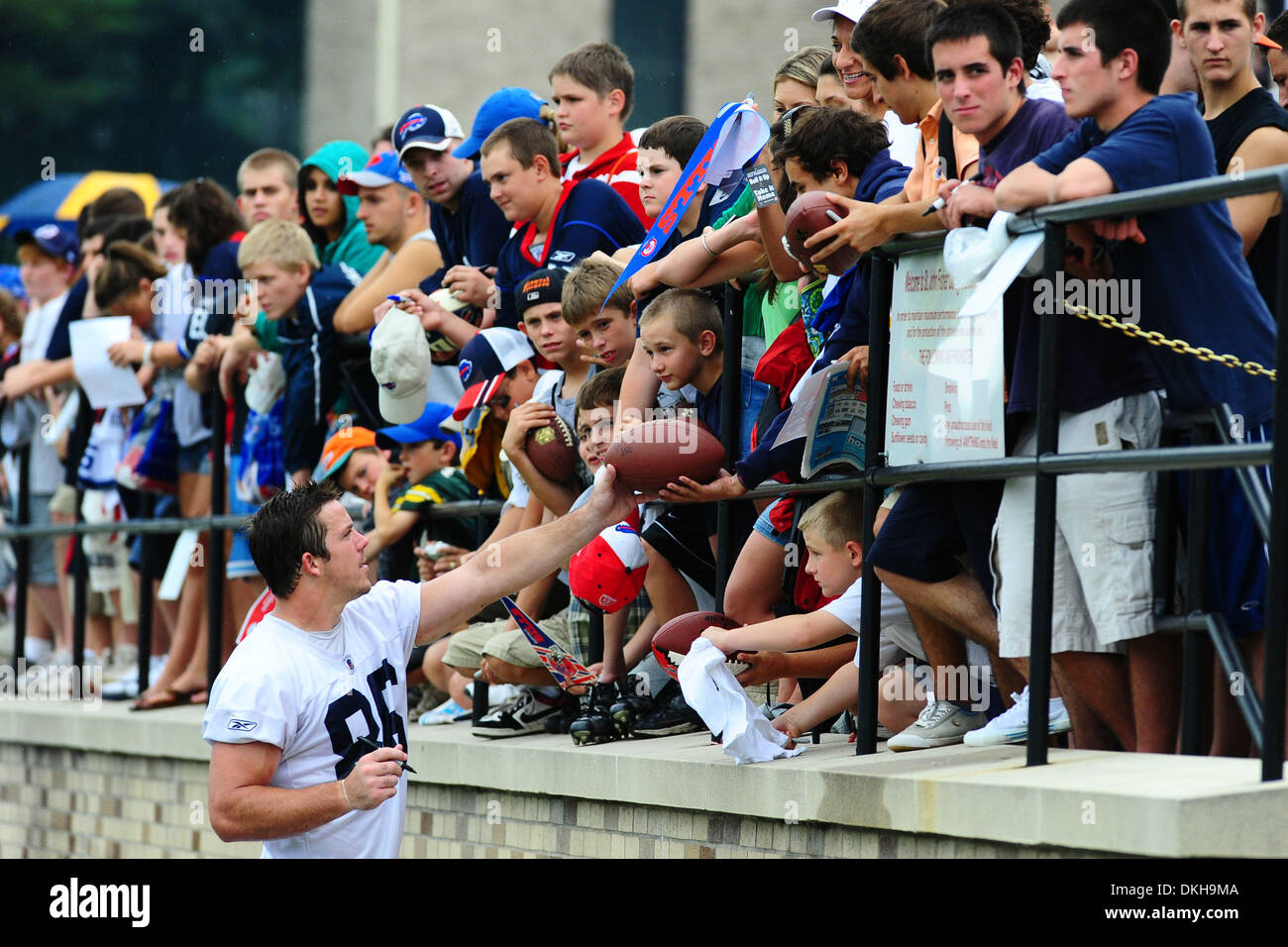 Buffalo Bill Derek Fine hands a young fan an autographed football ...