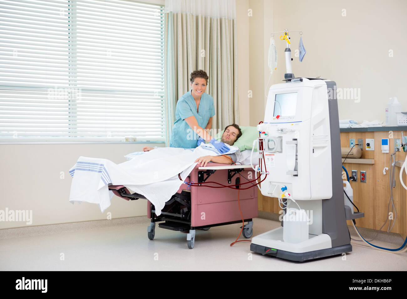 Portrait Of Nurse By Patient Receiving Renal Dialysis Stock Photo - Alamy