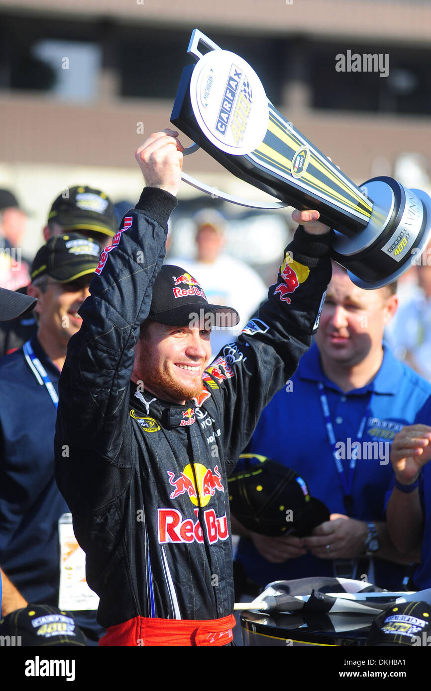 Race winner Brian Vickers raises the trophy in victory lane after ...