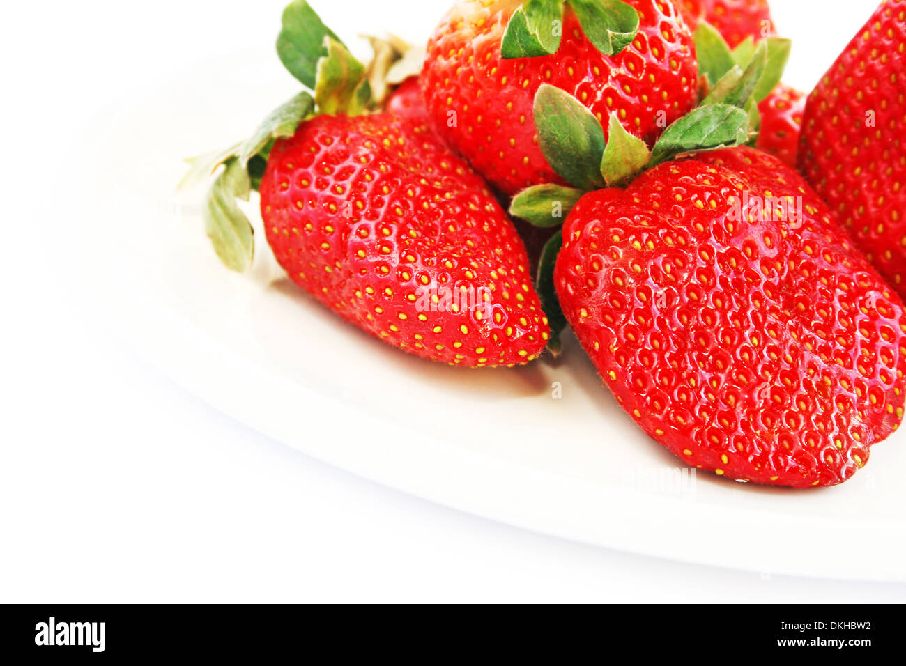 Strawberries on plate isolated on white background Stock Photo - Alamy