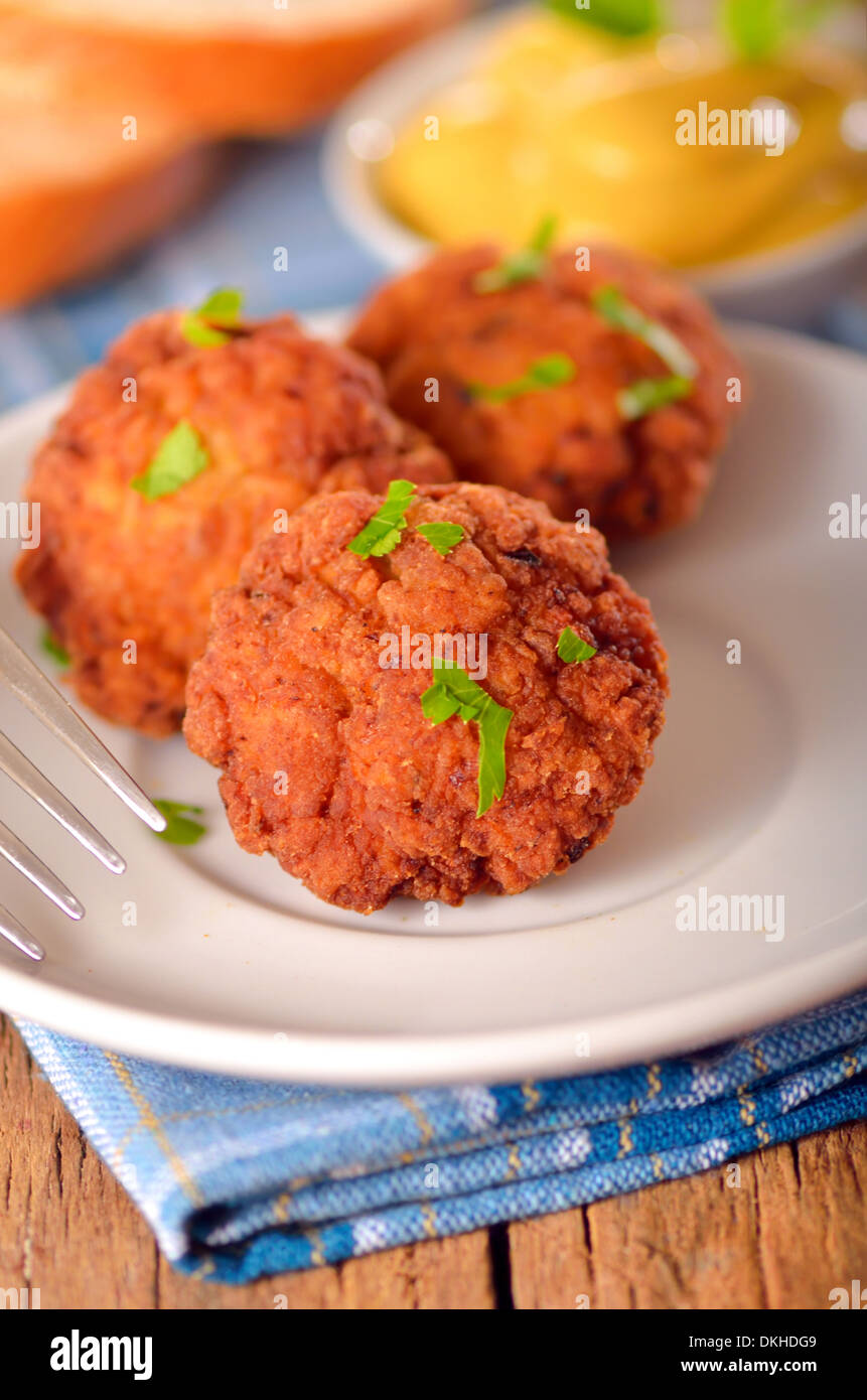meat balls with mustard on white dish on wooden backgrounds Stock Photo ...