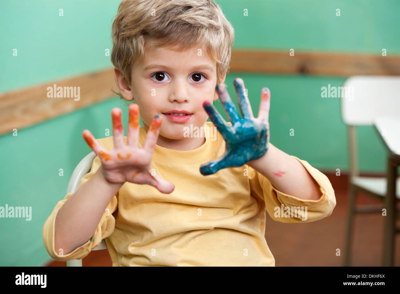 Boy Showing Colored Palms In Art Class Stock Photo - Alamy