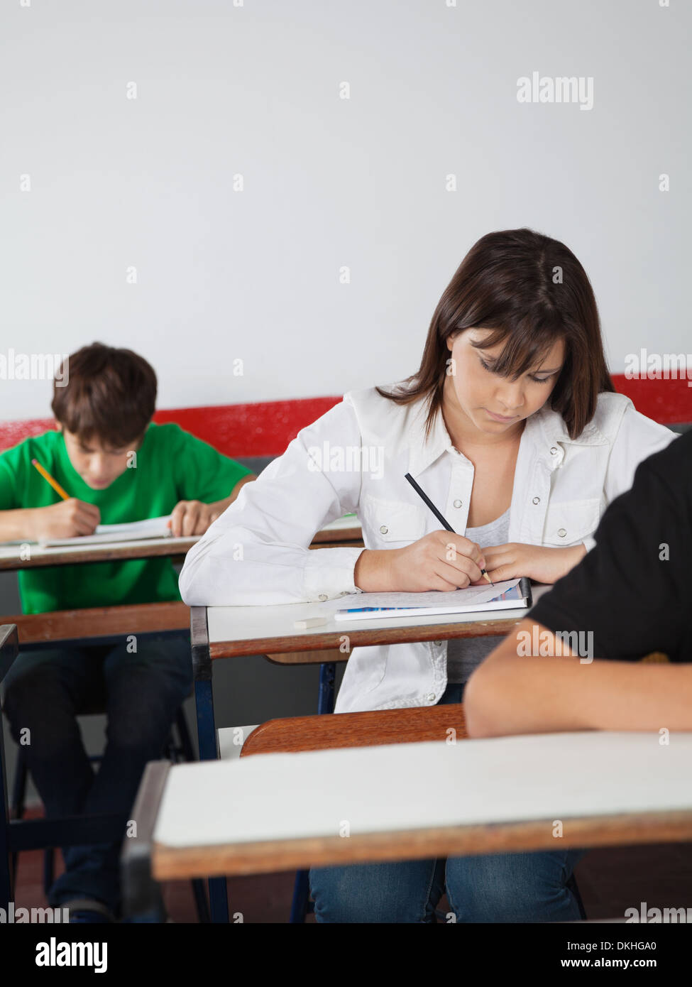 Schoolgirl Writing Paper At Desk Stock Photo - Alamy