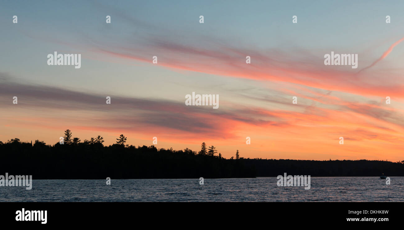 Sunset silhouette of trees at the lakeside, Kenora, Lake of The Woods ...