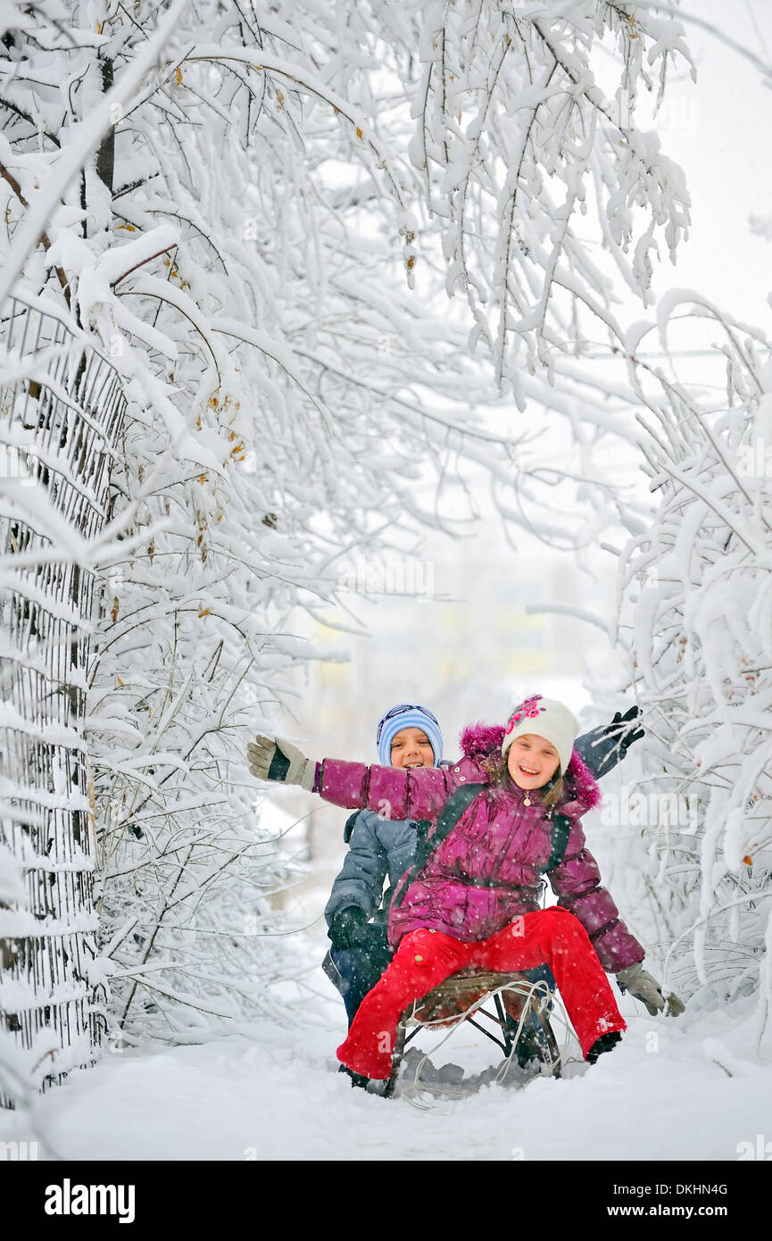 Kids sliding in winter time Stock Photo - Alamy