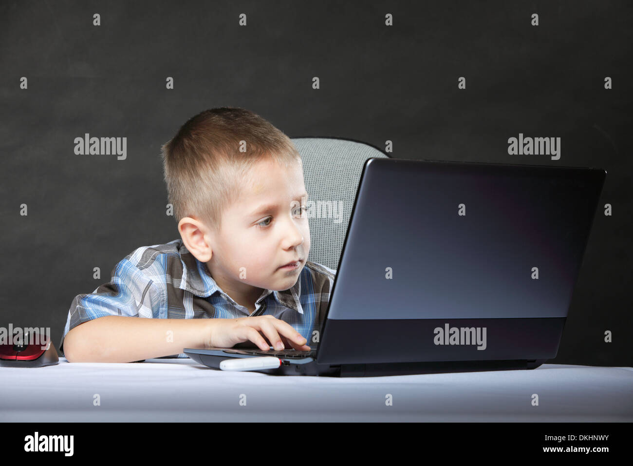 Computer addiction child boy with laptop notebook black background ...