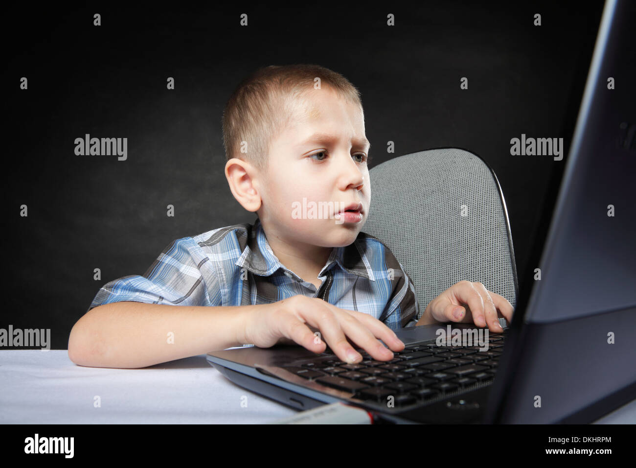 Computer addiction child boy with laptop notebook black background ...