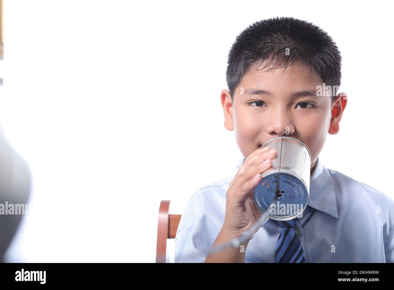 Lovely boy listen tin can telephone in studio Stock Photo - Alamy