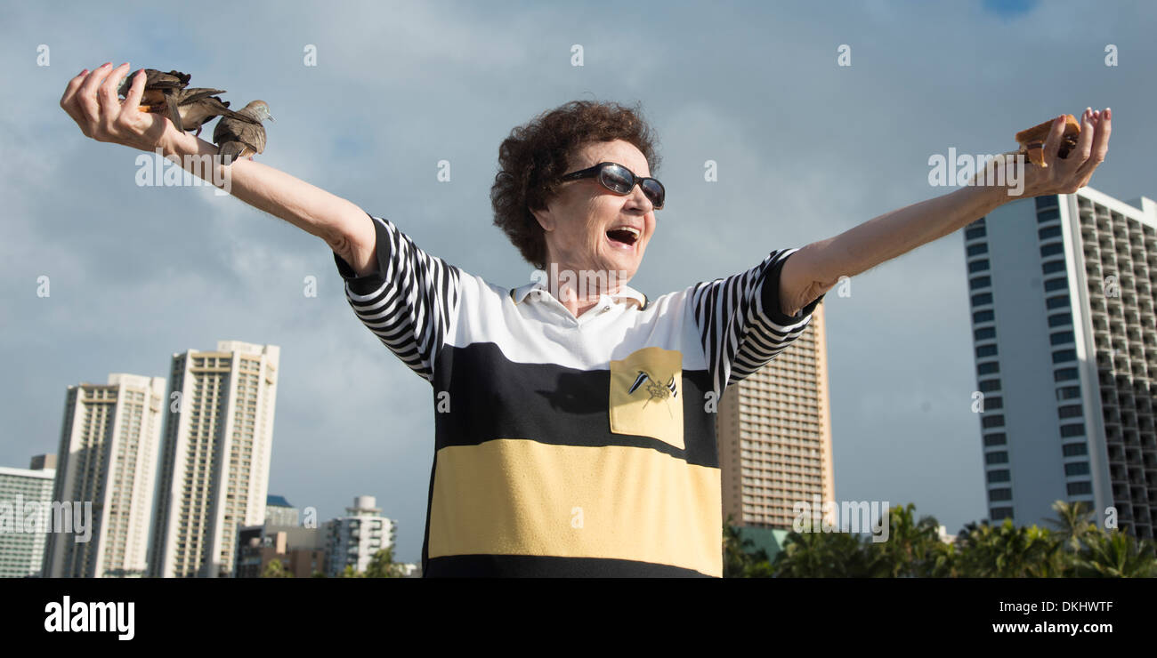 Woman with pigeons on her outstretched arms, Waikiki, Diamond Head ...