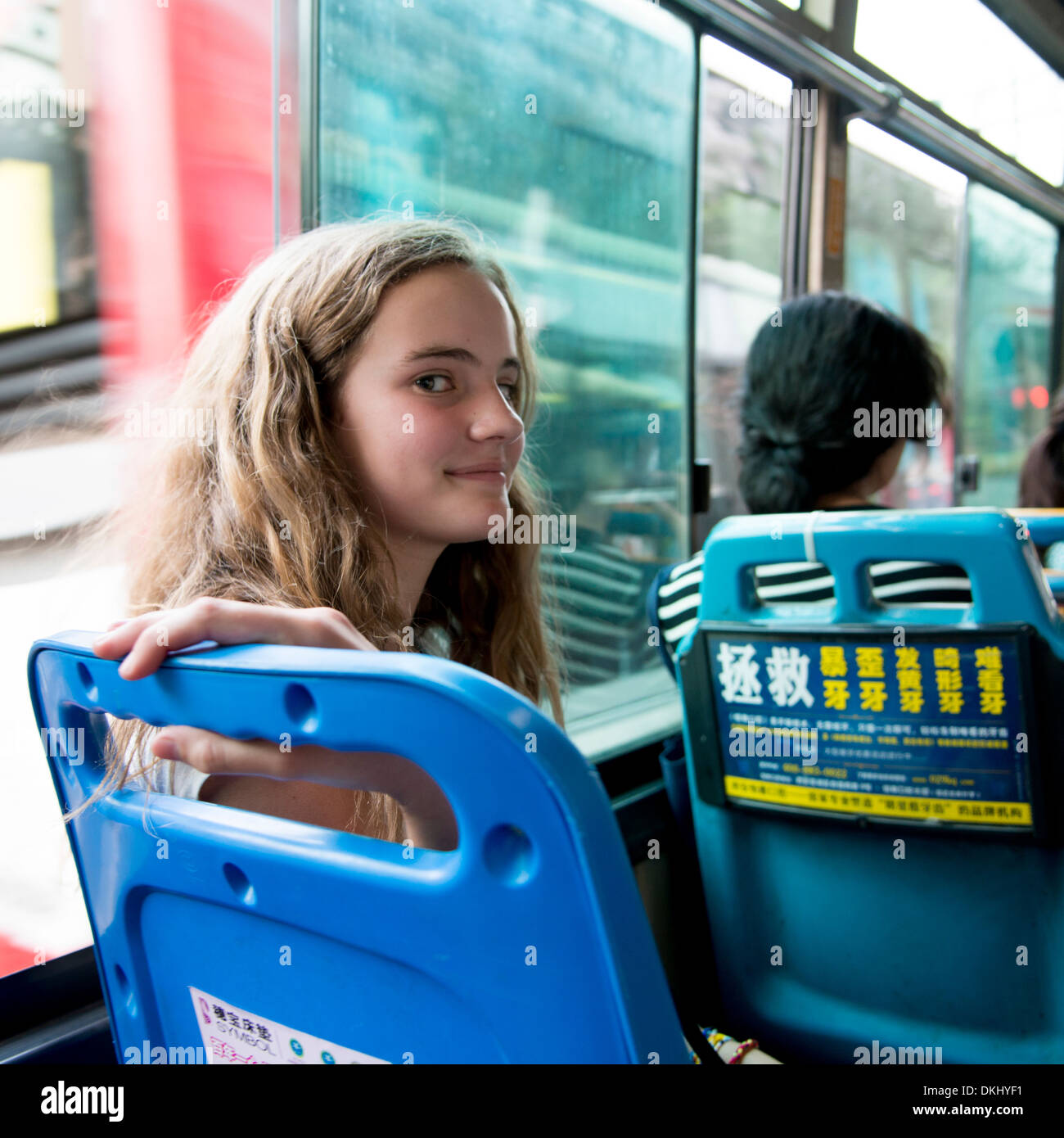 Portrait of a cute teenage girl smiling in tour bus, Xi'an, Shaanxi ...