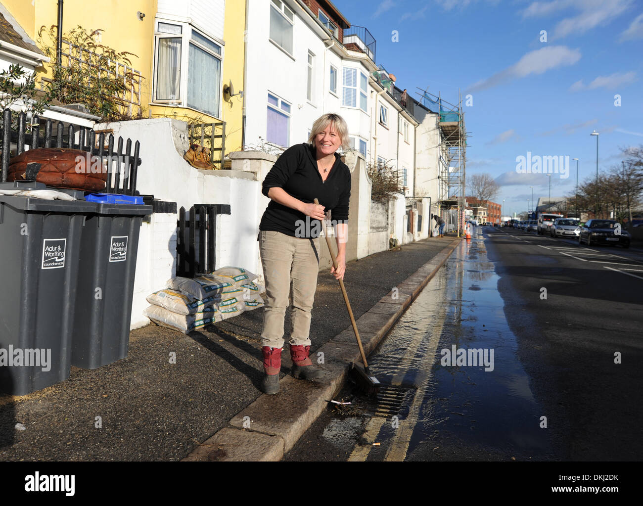 Resident Lucy gabriel sweeping away flood water after homes and ...