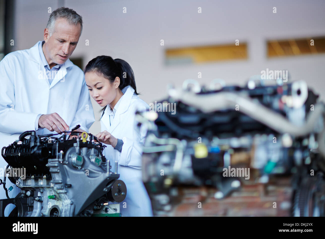 Scientists working on machine Stock Photo - Alamy