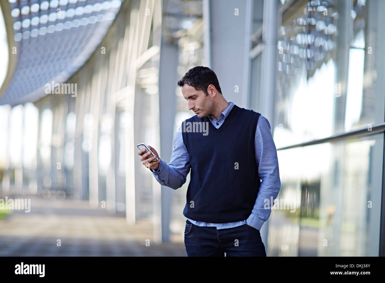 Businessman using cell phone outdoors Stock Photo - Alamy