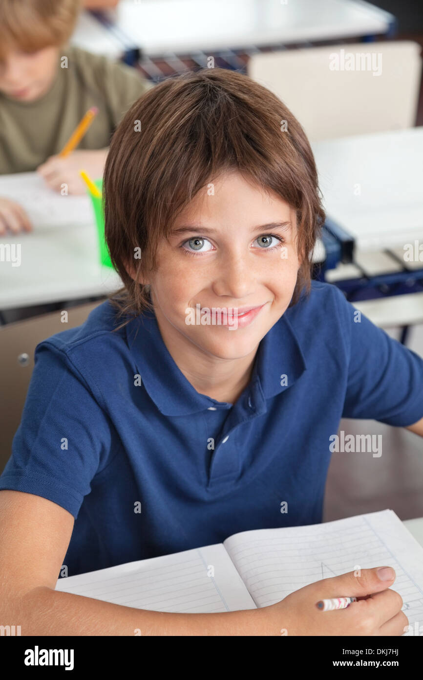 Cute Schoolboy Smiling In Classroom Stock Photo - Alamy