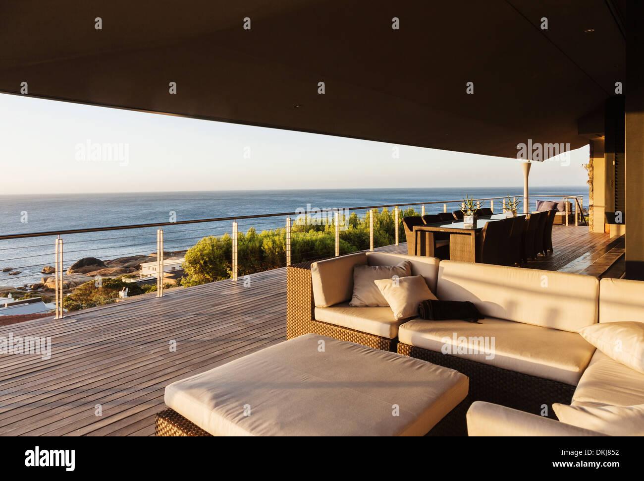 Sofa and table on luxury patio overlooking ocean Stock Photo - Alamy